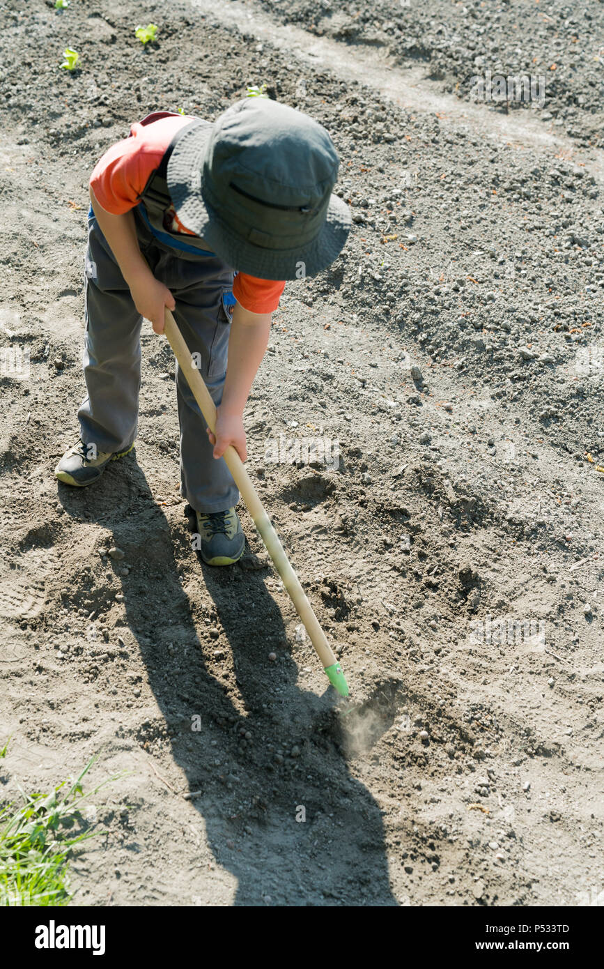Child plowing soil hi-res stock photography and images - Alamy