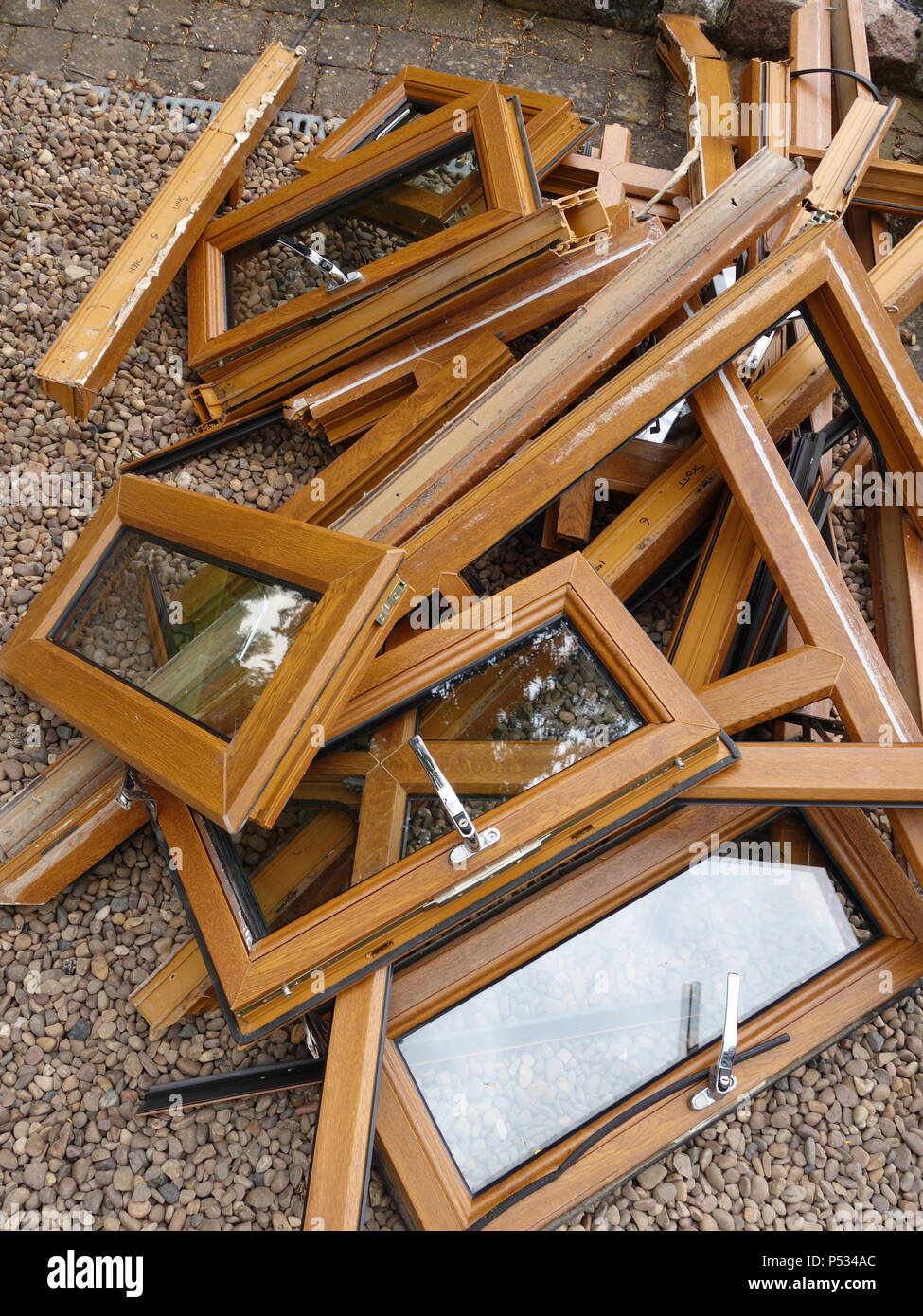A pile of scrapped plastic wood effect ex window frames being replaced ...
