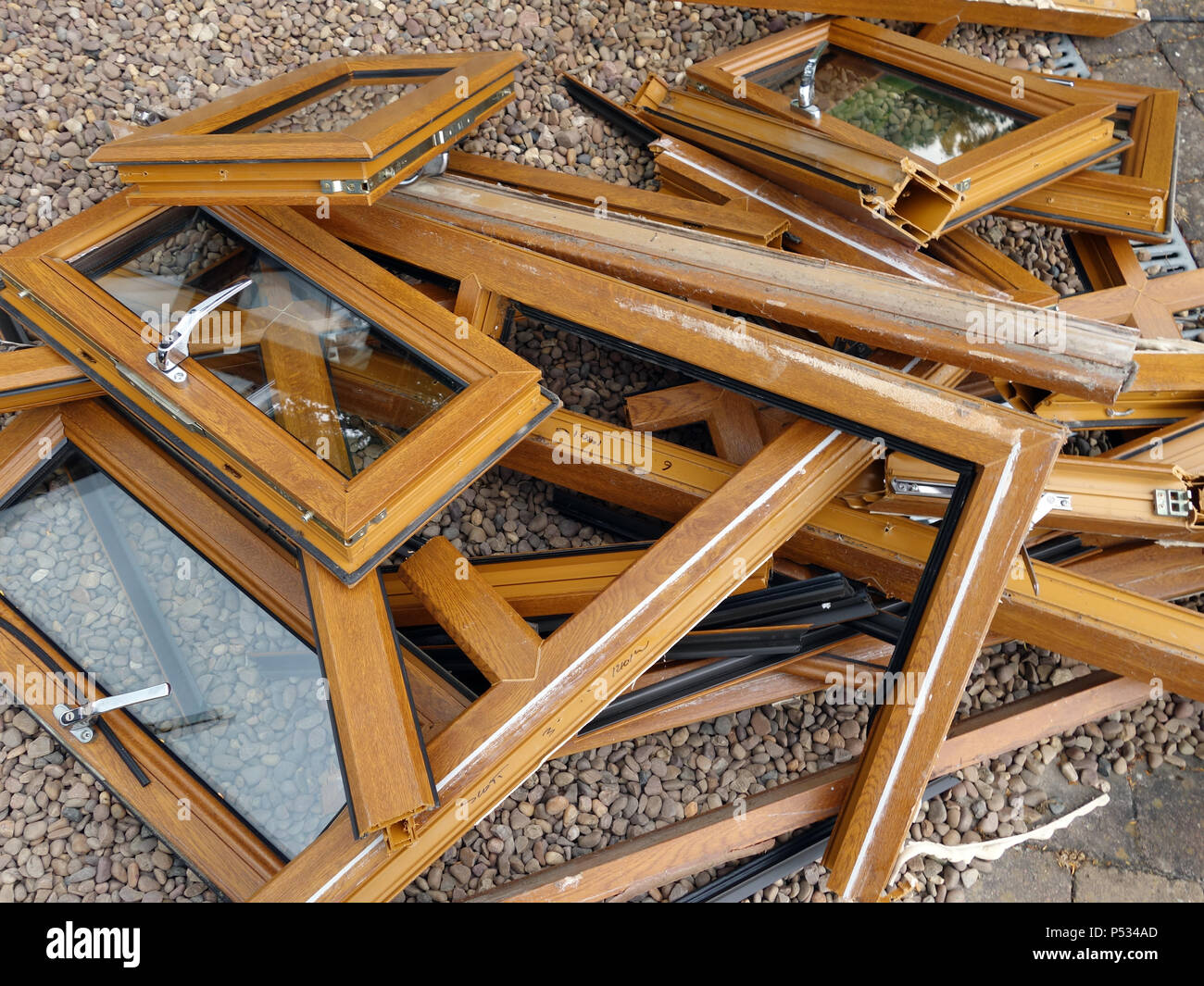 A pile of scrapped plastic wood effect ex window frames being replaced ...