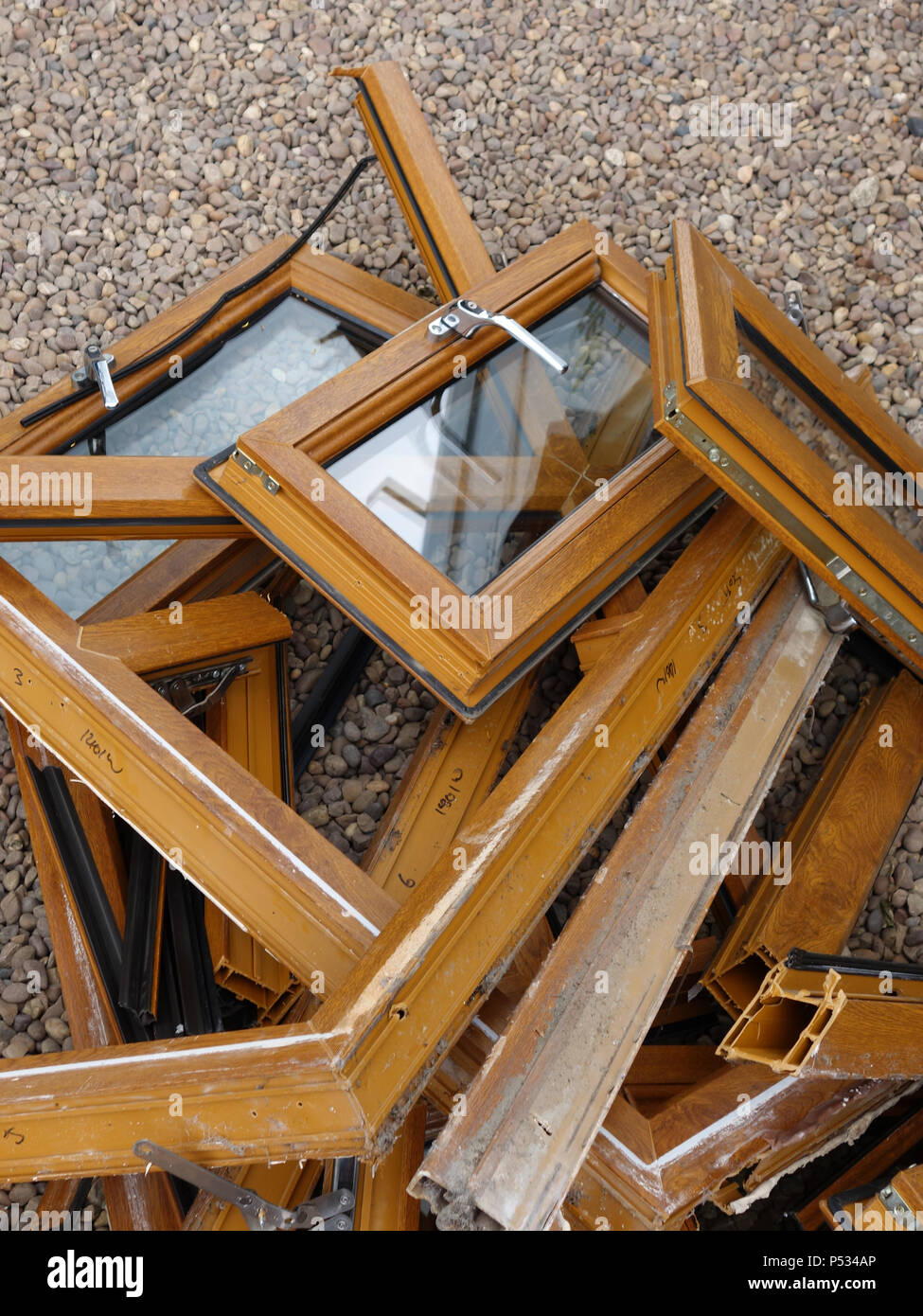 A pile of scrapped plastic wood effect ex window frames being replaced ...