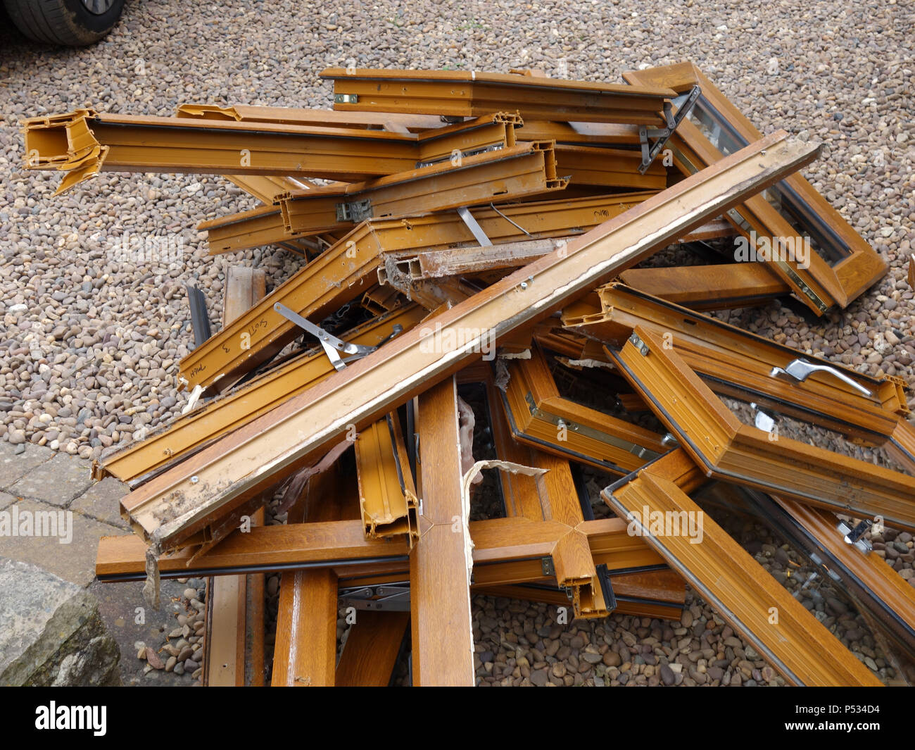 A pile of scrapped plastic wood effect ex window frames being replaced ...