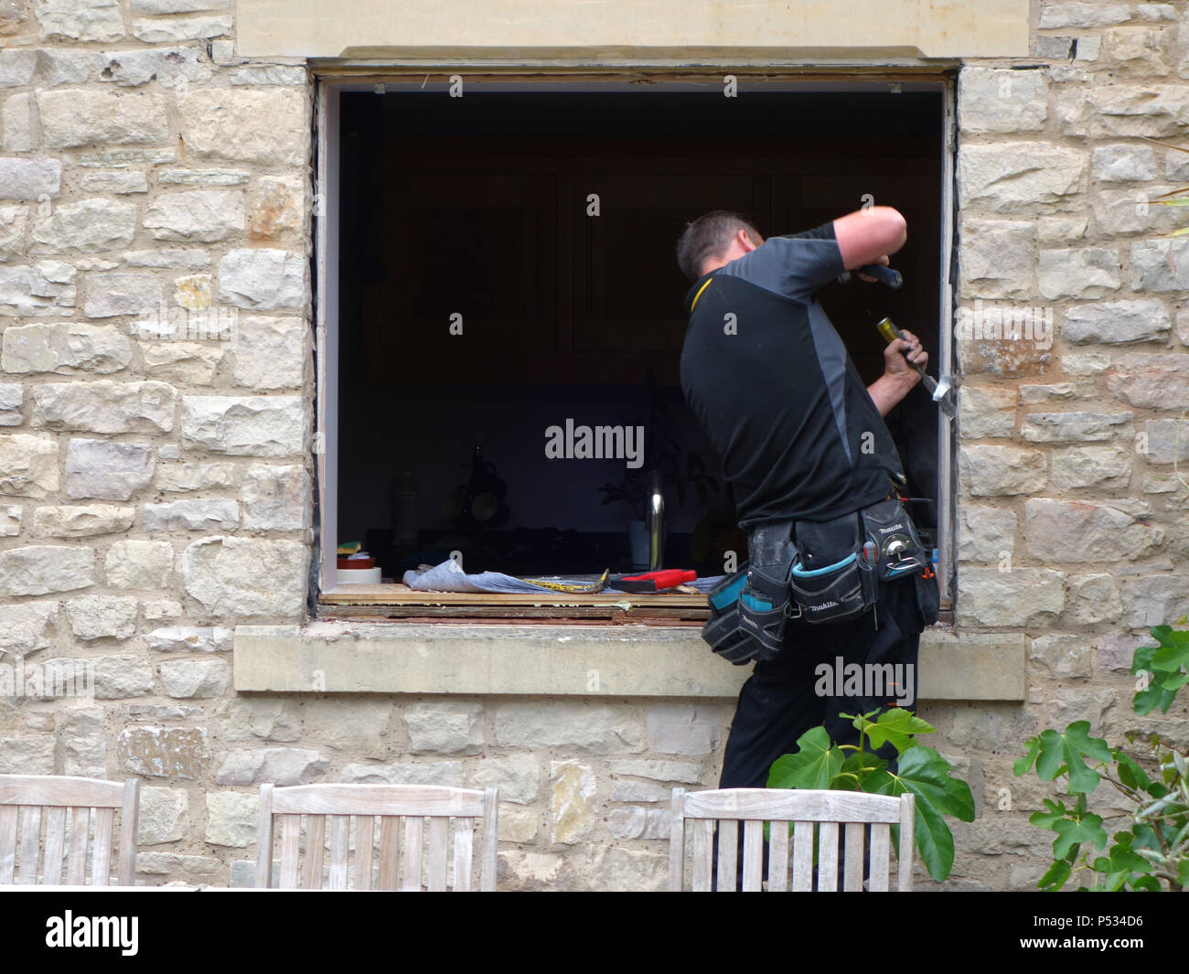 Window fitter replacing old double glazed uPVC window frames with new ...