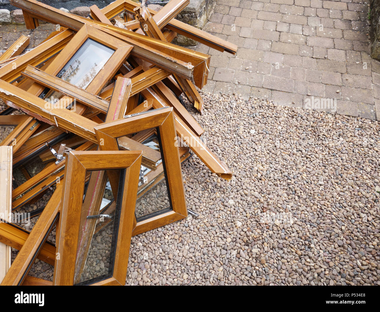 A pile of scrapped plastic wood effect ex window frames being replaced ...