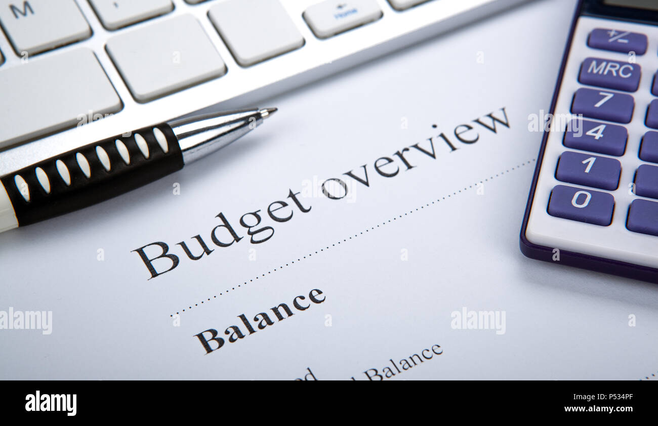 document with title budget overview and keyboard, calculator close up ...