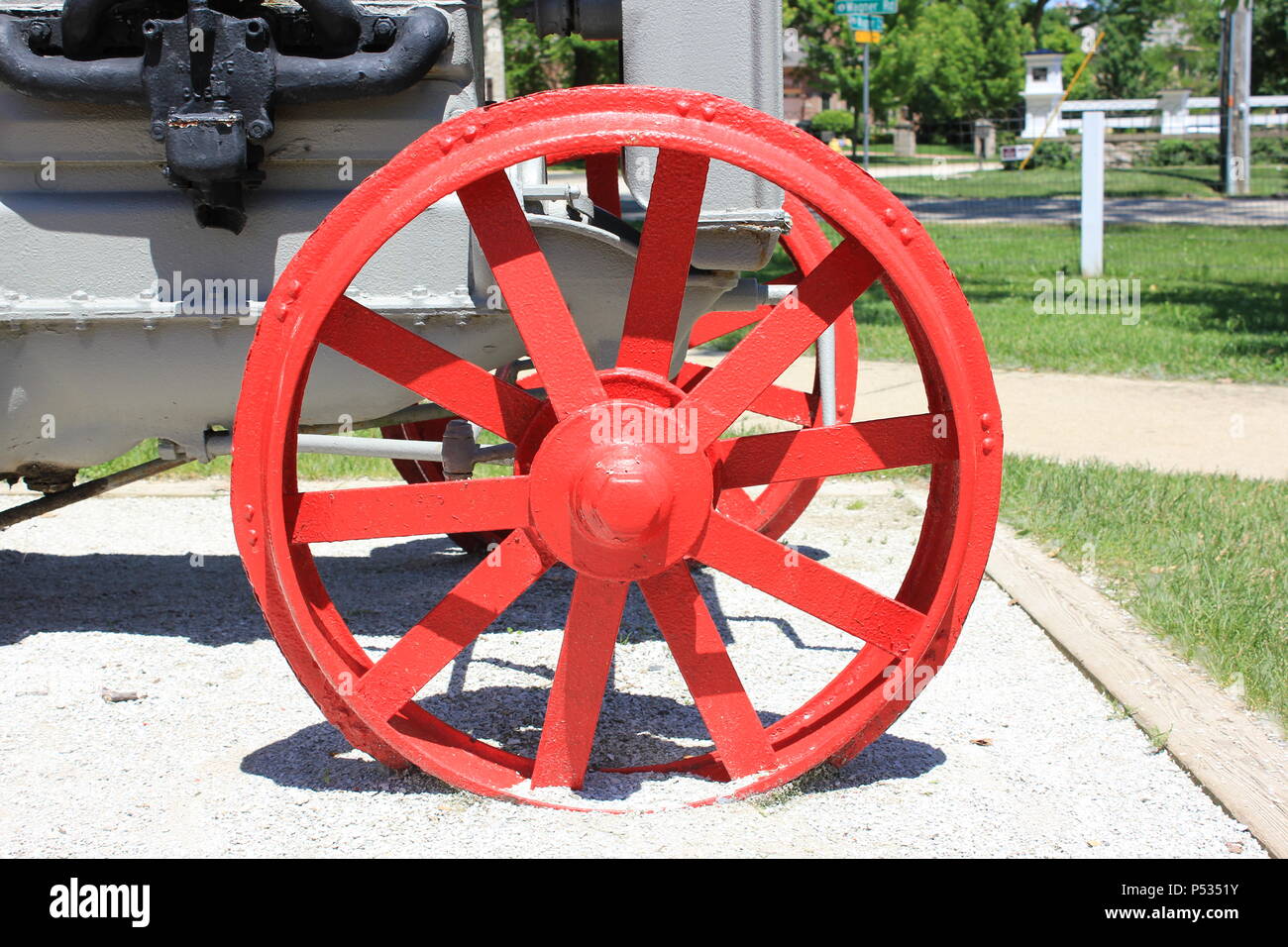 A bright red metal historic wagon wheel Stock Photo - Alamy