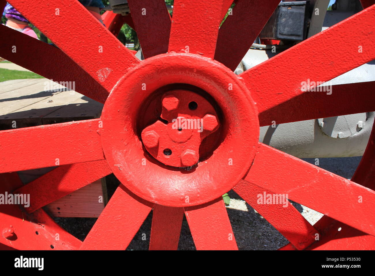 A bright red metal historic wagon wheel Stock Photo - Alamy