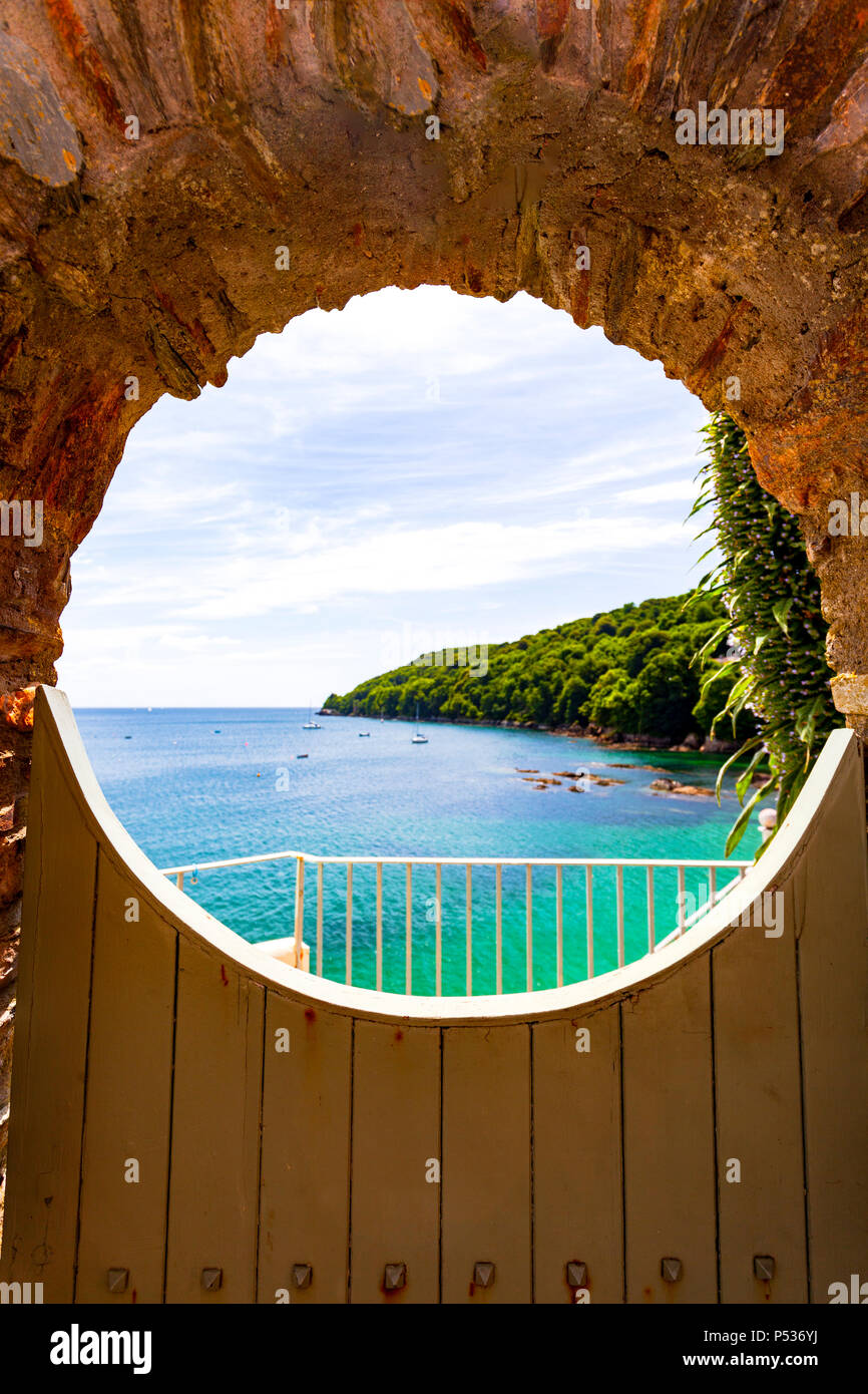 A gate with stone arch giving with a beautiful summers view of Cawsand ...