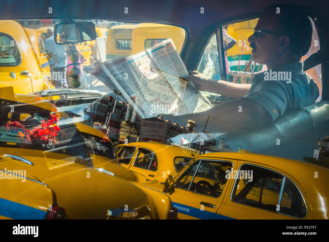 A taxi driver in a queue of Hindustan Ambassadors, the reflections of ...