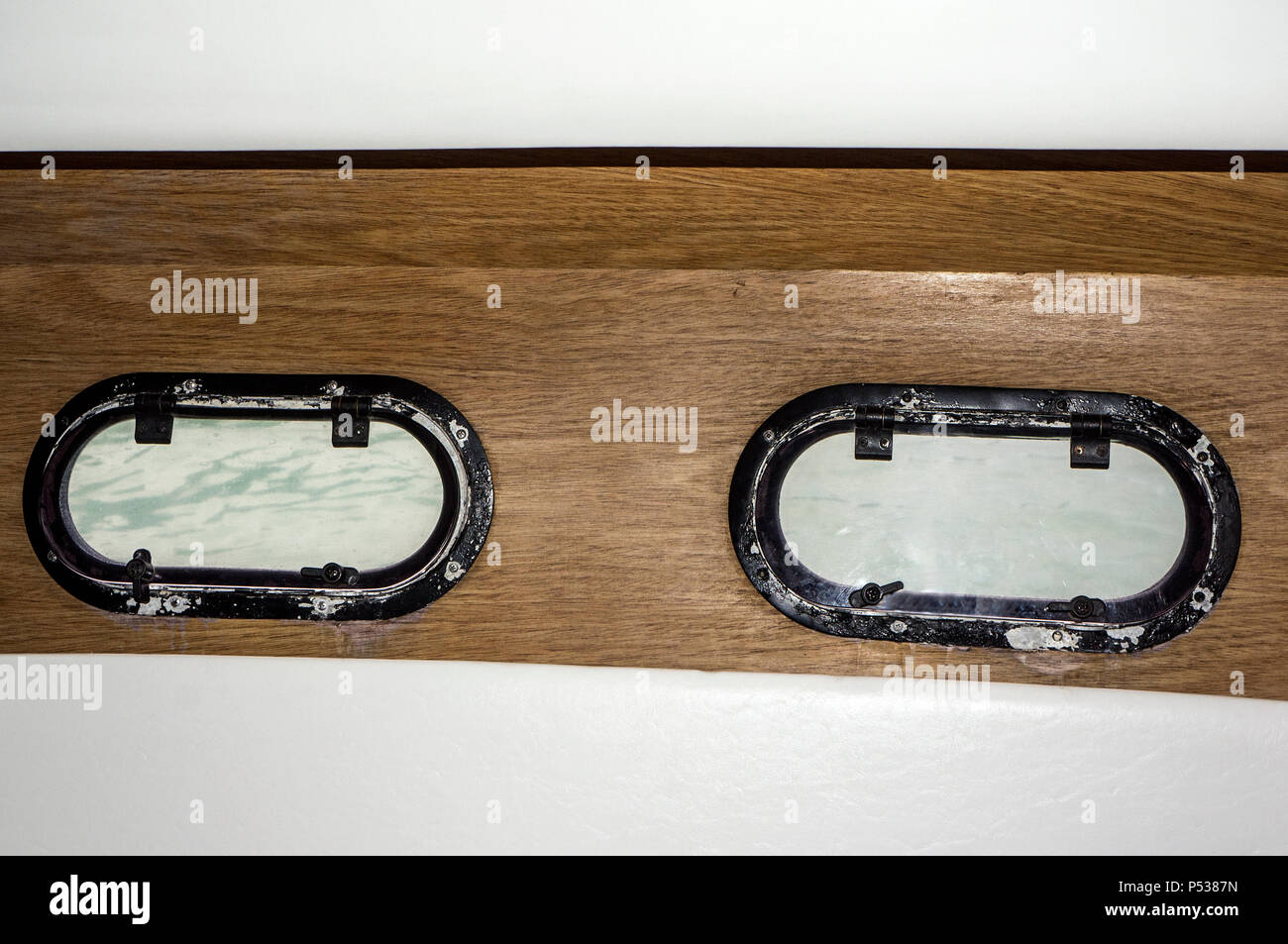 boat metal windows ocean view wooden wall maritime Stock Photo - Alamy