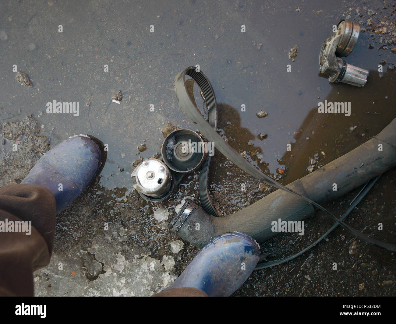 Man standing above the car engine parts ;aid on the ground Stock Photo ...
