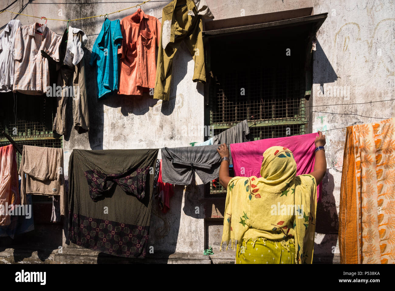 Indian woman drying clothes hi-res stock photography and images - Alamy