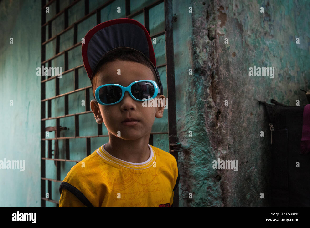 Portrait of a boy wearing sunglasses and a baseball cap in Kolkata ...