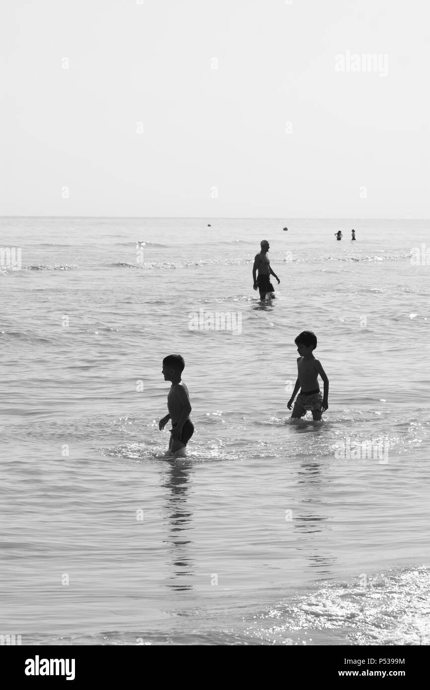 People wading in the sea at Hove, East Sussex Stock Photo - Alamy
