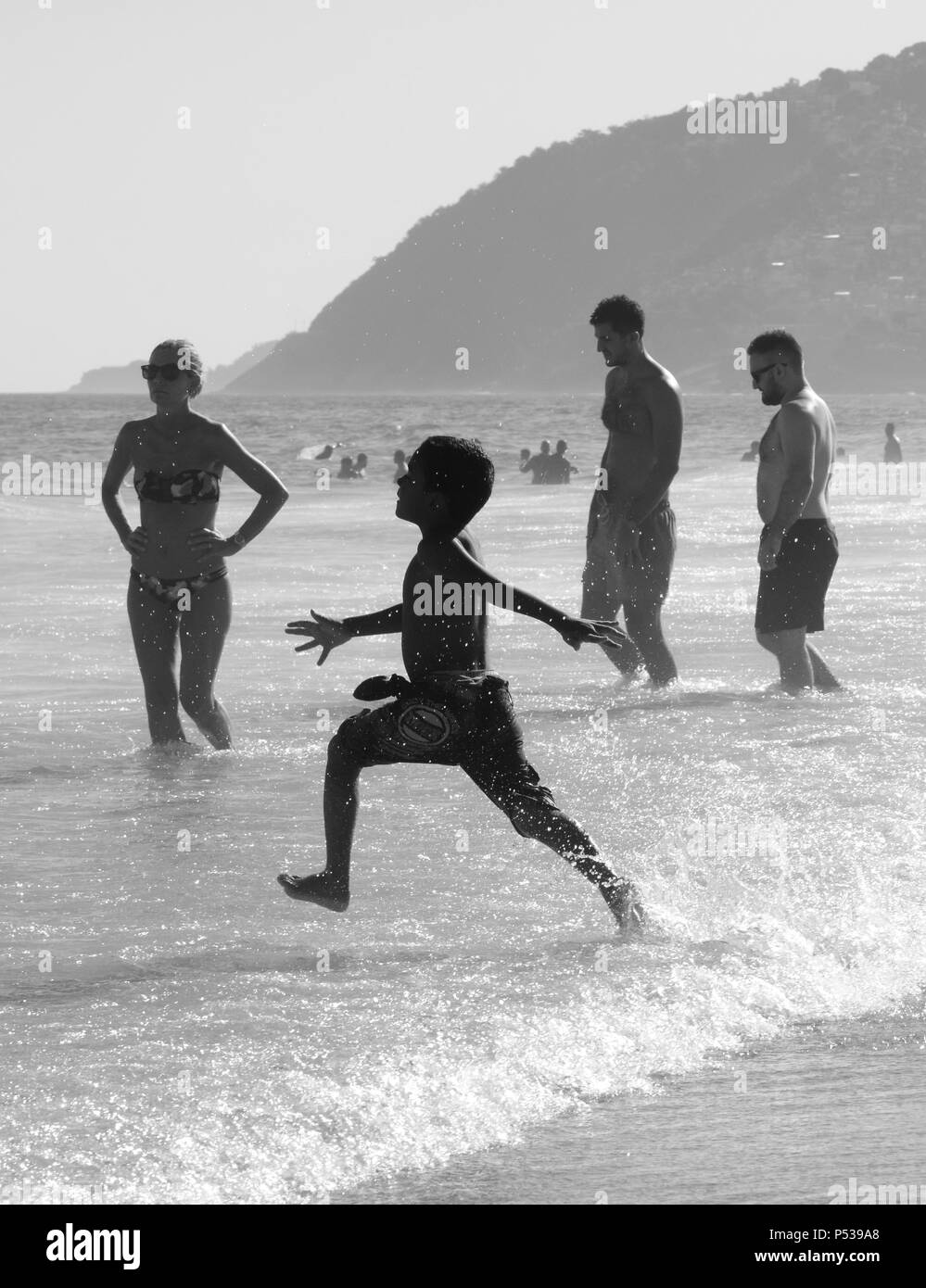 A boy running into waves at the beach, Ipanema, Rio de Janeiro Stock ...