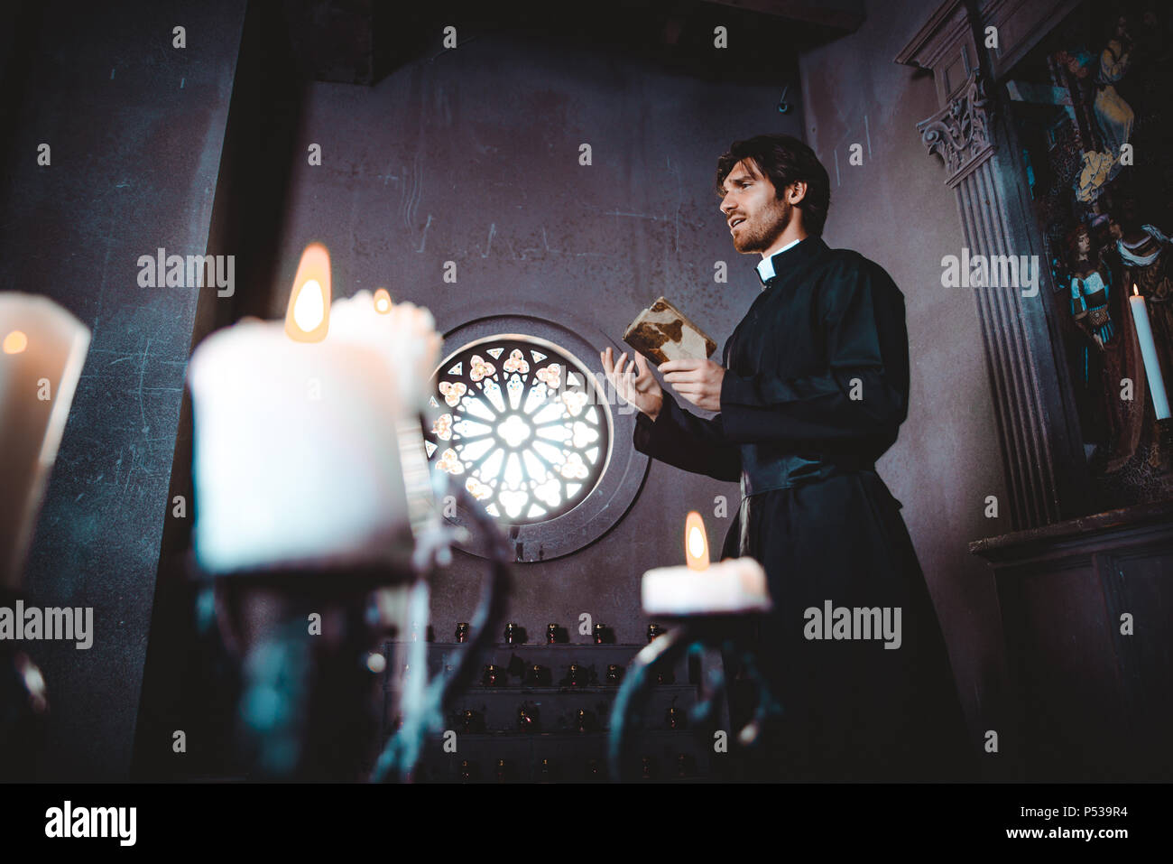 Priest reading and praying in the church Stock Photo - Alamy