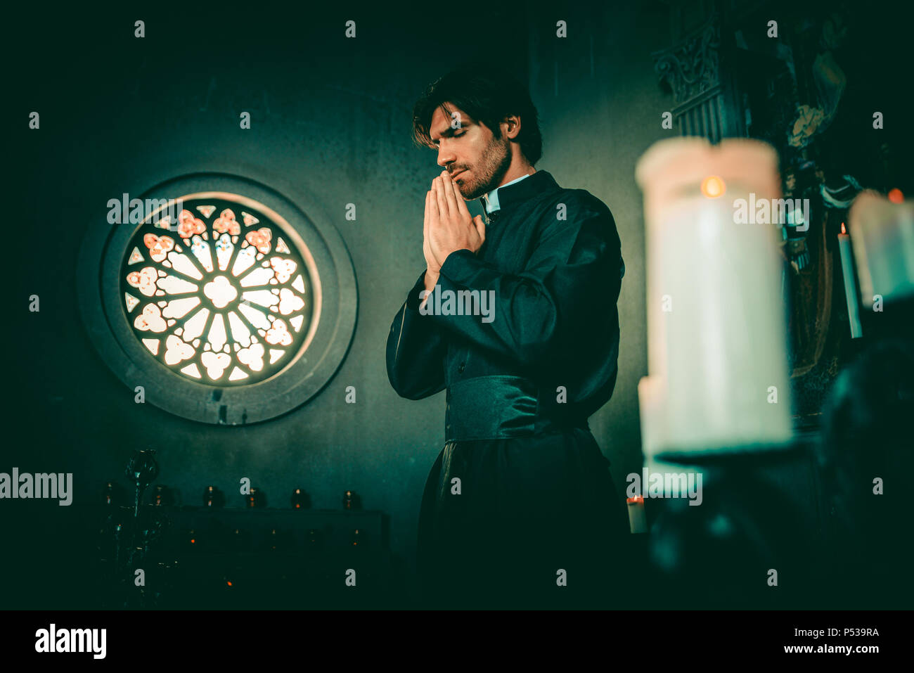 Priest reading and praying in the church Stock Photo - Alamy