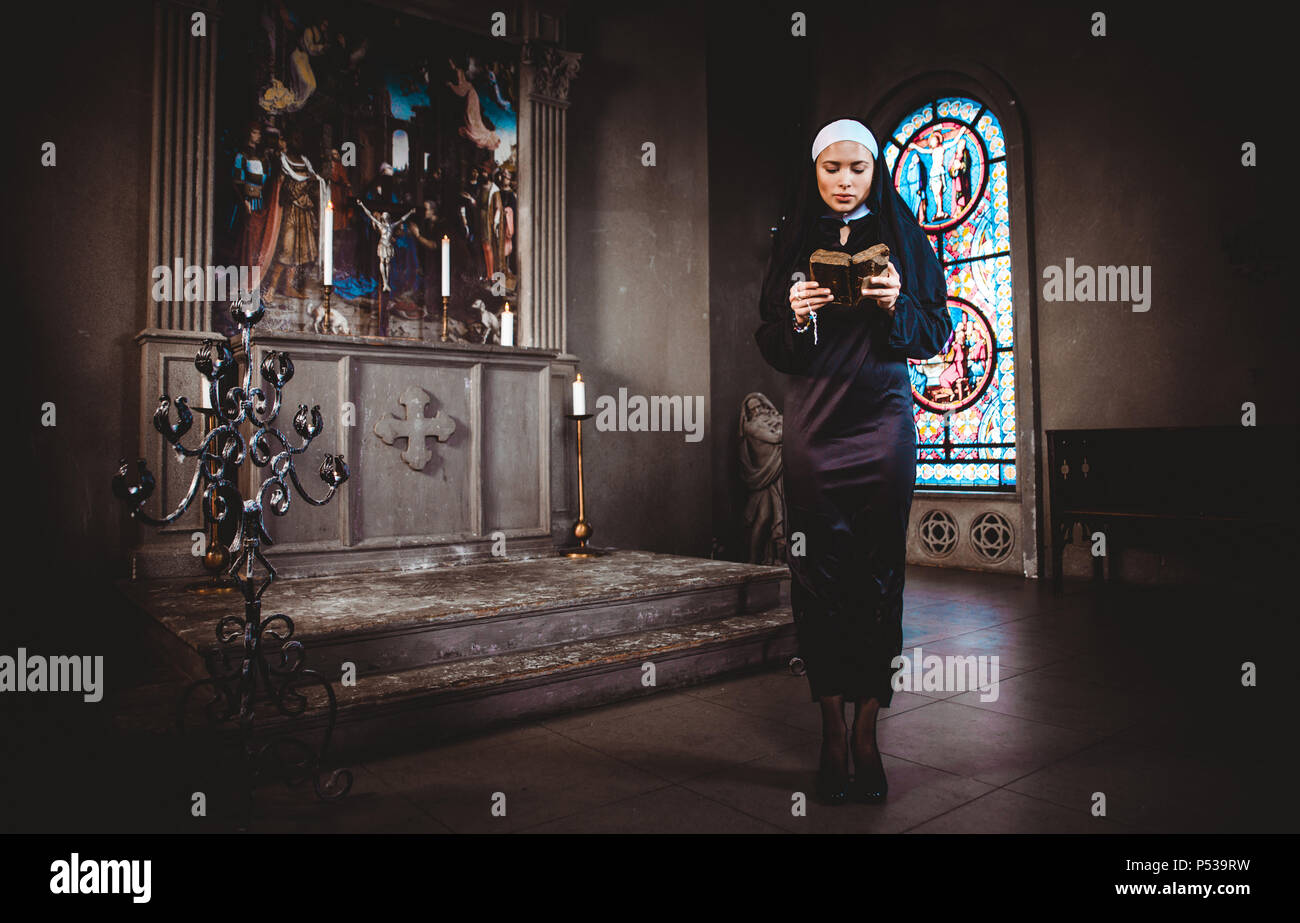 Nun praying in a monastery Stock Photo - Alamy