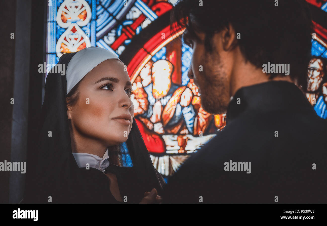 Nun and priest praying and spending time in the monastery Stock Photo ...