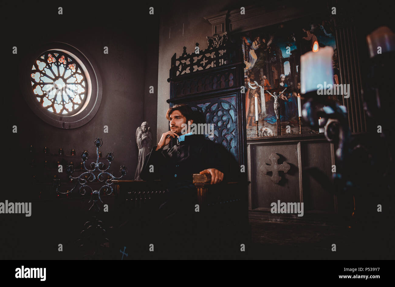 Priest reading and praying in the church Stock Photo - Alamy