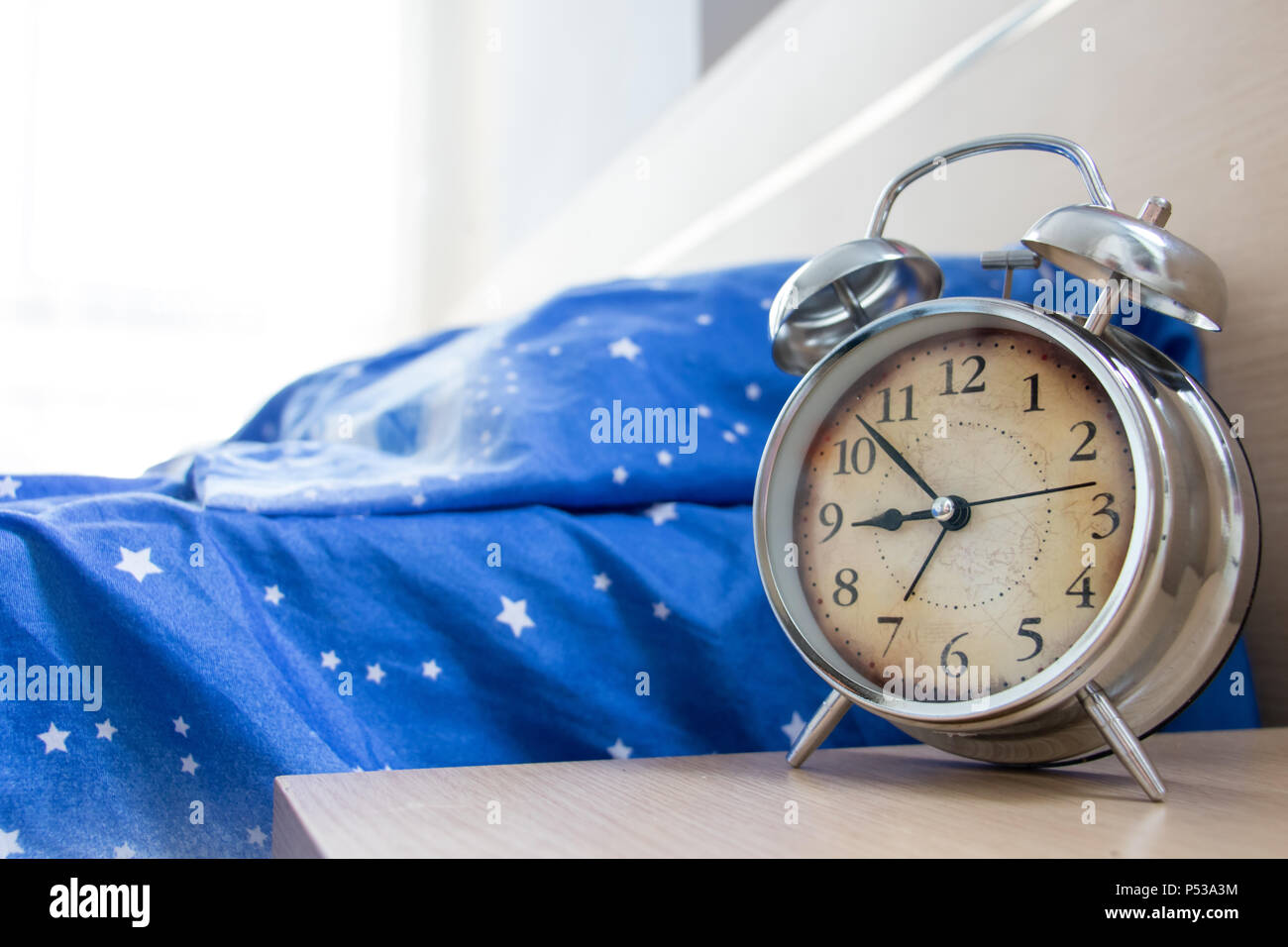 A Deserted Bed With An Alarm Clock On The Bedside Table A Classic