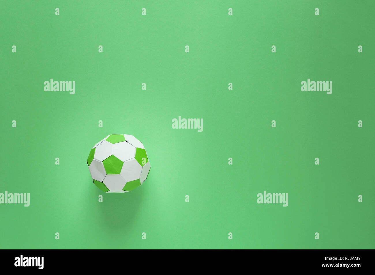 Paper soccer ball on soccer field or green background. Origami. Paper ...