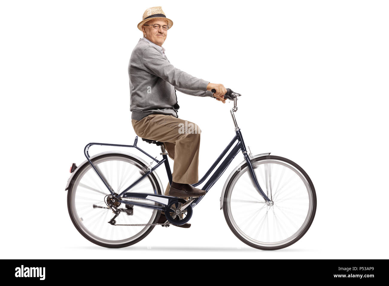 Senior riding a bike and looking at the camera isolated on white ...