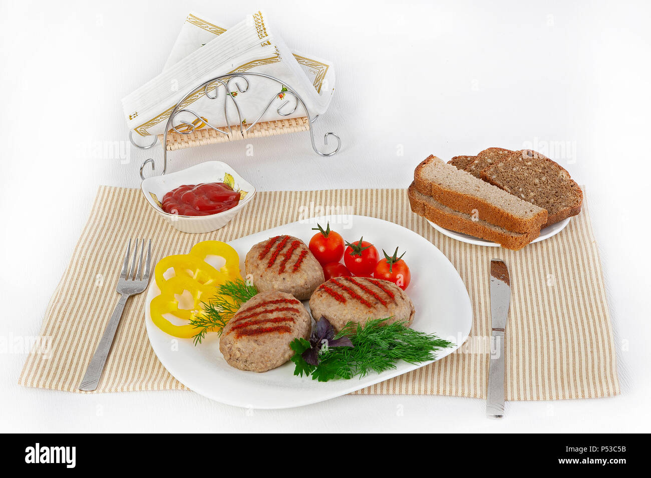 Cutlets with greens, tomatoes and cucumbers. Serve with black or white ...