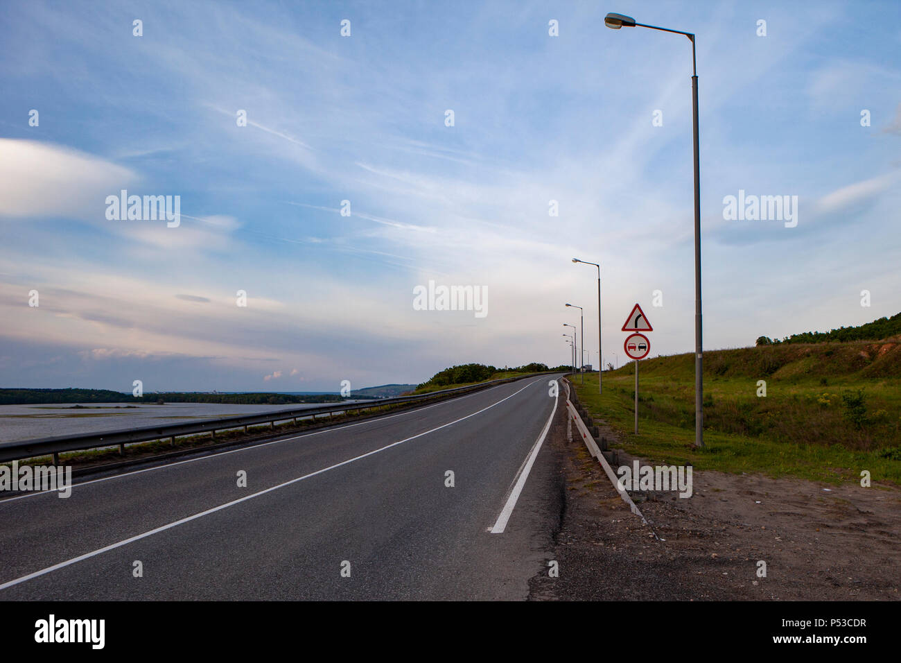 An empty road with lanterns on the shore of the great Volga river Stock ...