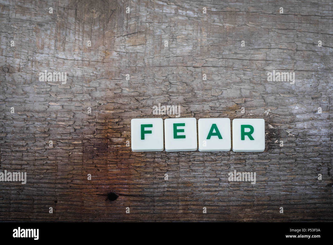 Word Fear, letters on the rustic background, toned vintage Stock Photo ...