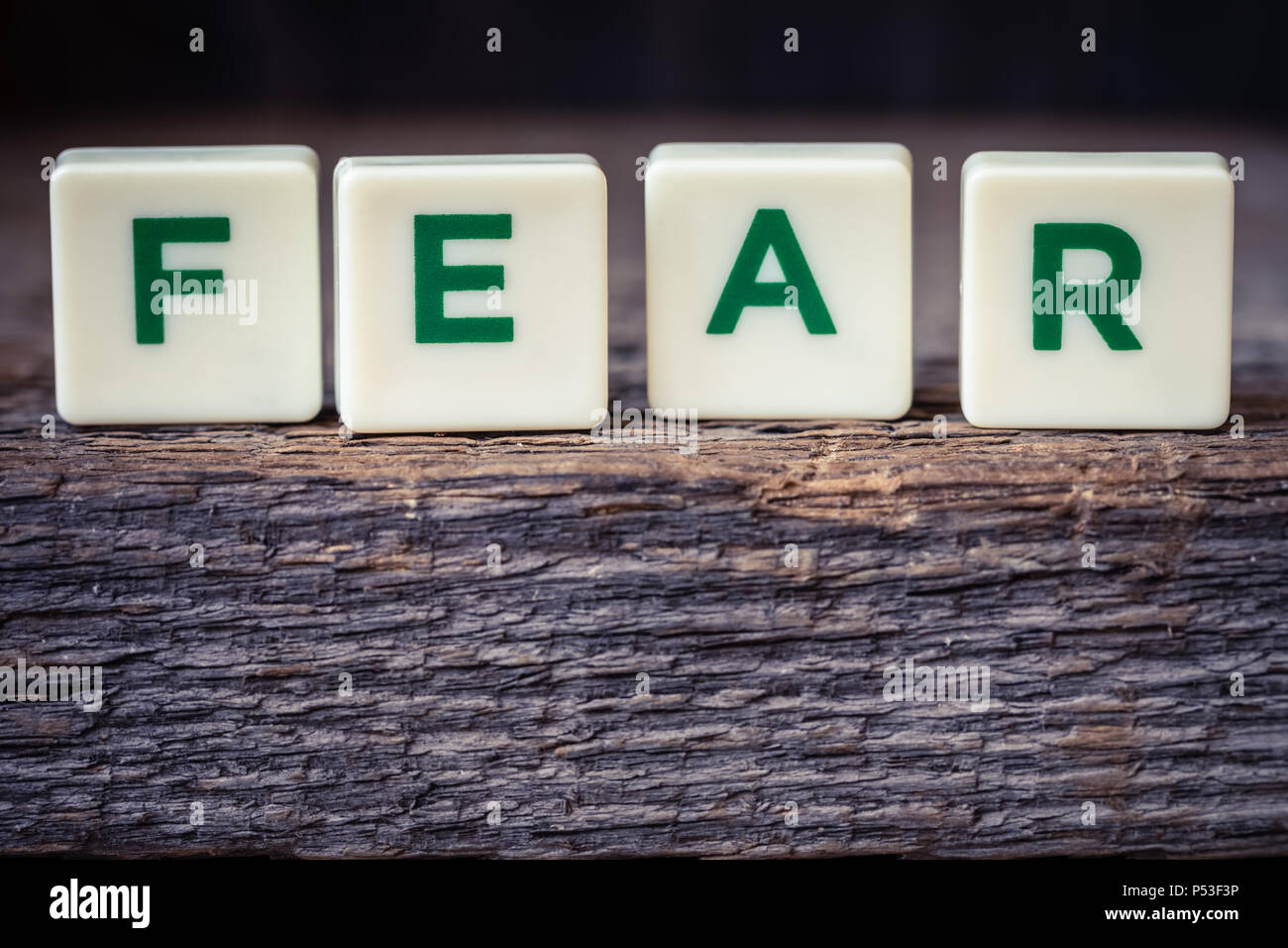 Word Fear, letters on the rustic background, toned vintage Stock Photo ...