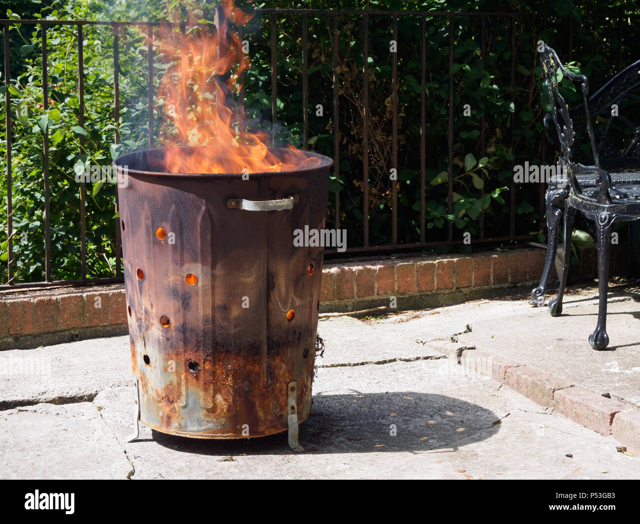 Destruction of garbage by means of burning in a Garden incinerator bin ...