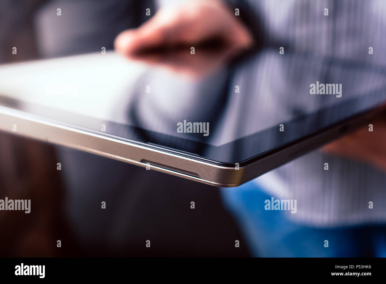 Man Holding Tablet With Reflection In His Hands Stock Photo - Alamy