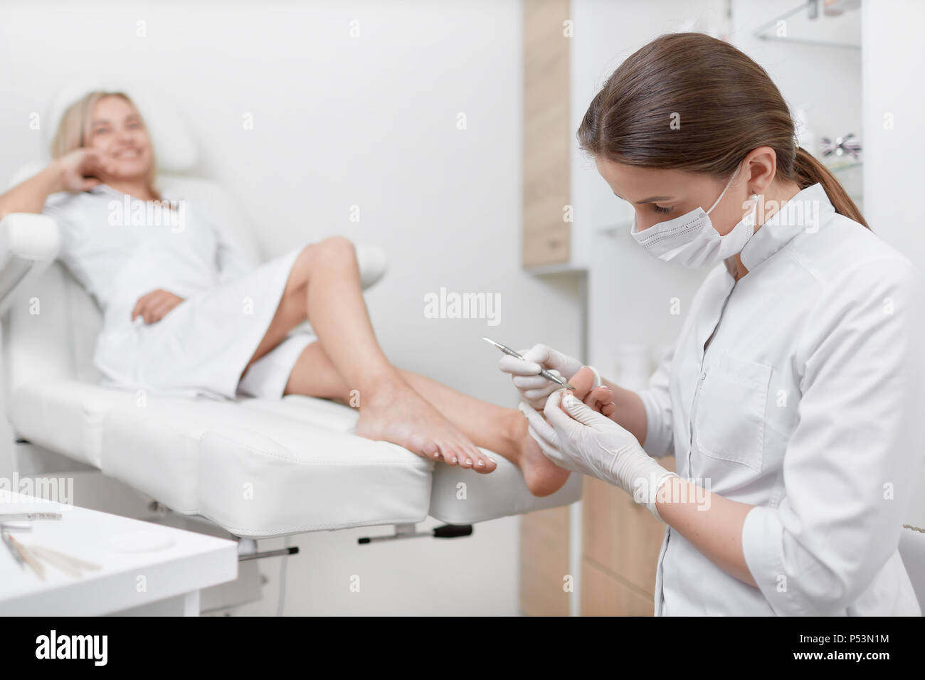 Podiatrist doctor making procedure for clients feet with special long ...