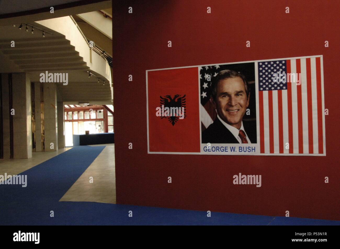 Poster of George Bush, along with the flags of Albania and the United ...