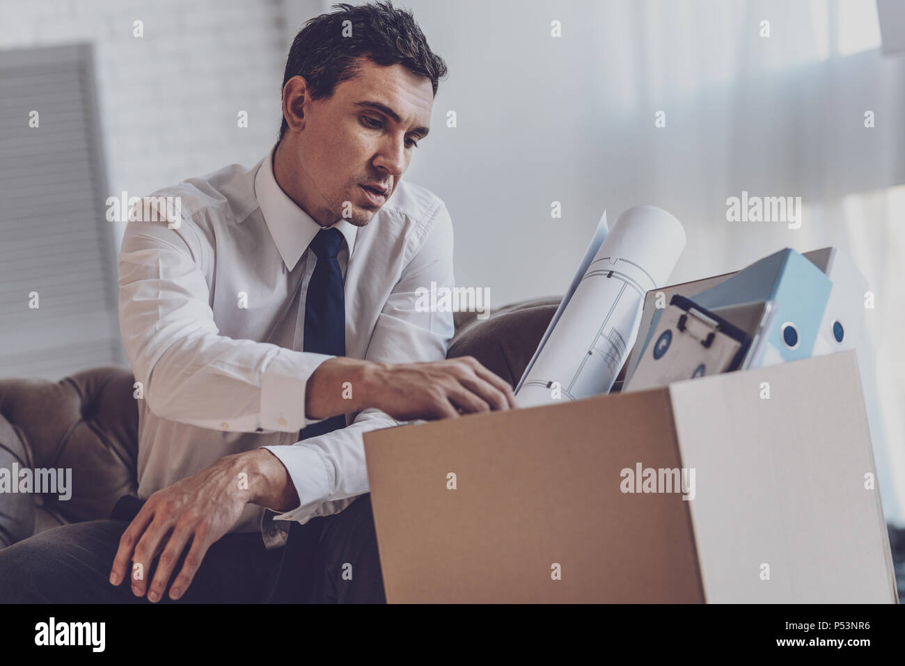 Cheerless young man being unemployed Stock Photo - Alamy