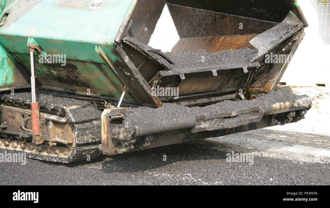 Paving work. Asphalt paving machine. New asphalt surface on the ...