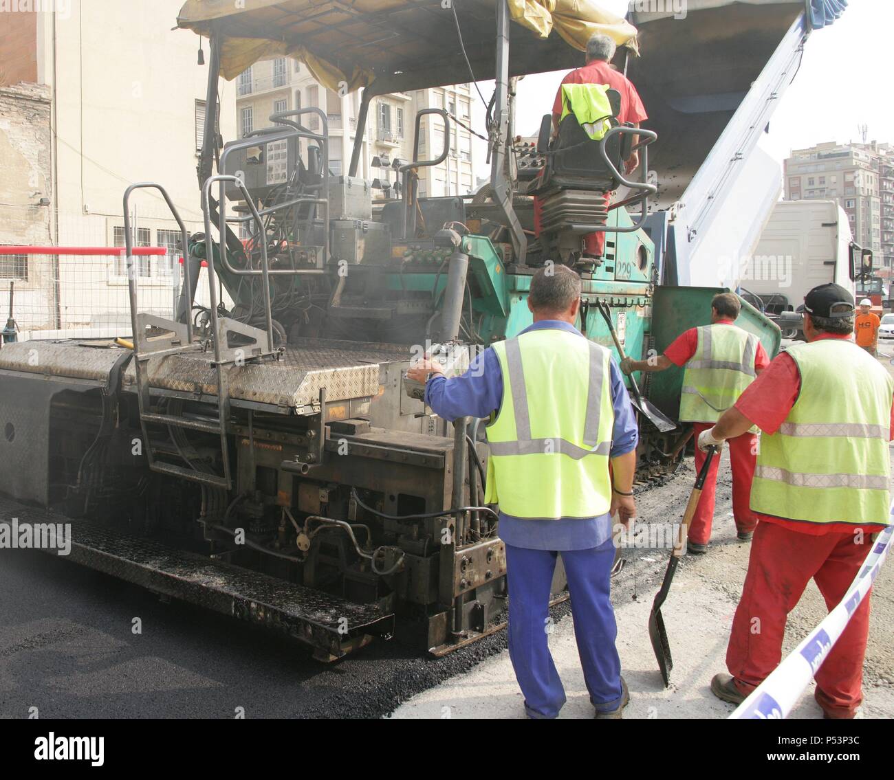 Paving work. Asphalt paving machine. New asphalt surface on the ...