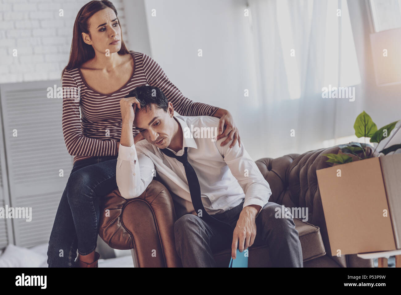 Sad nice man being supported by his wife Stock Photo - Alamy