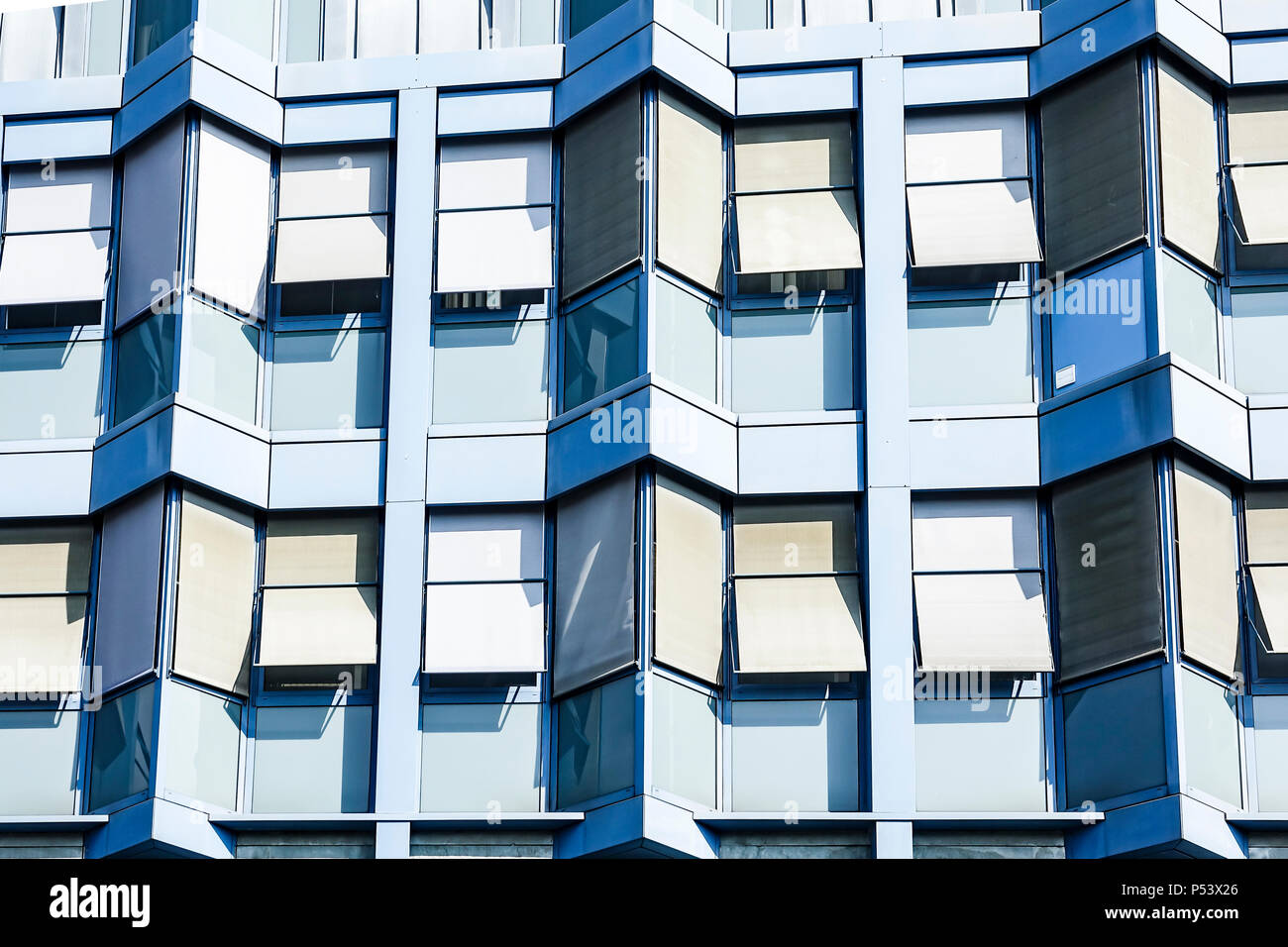 Front facade of a contemporary blue office building with arched window ...