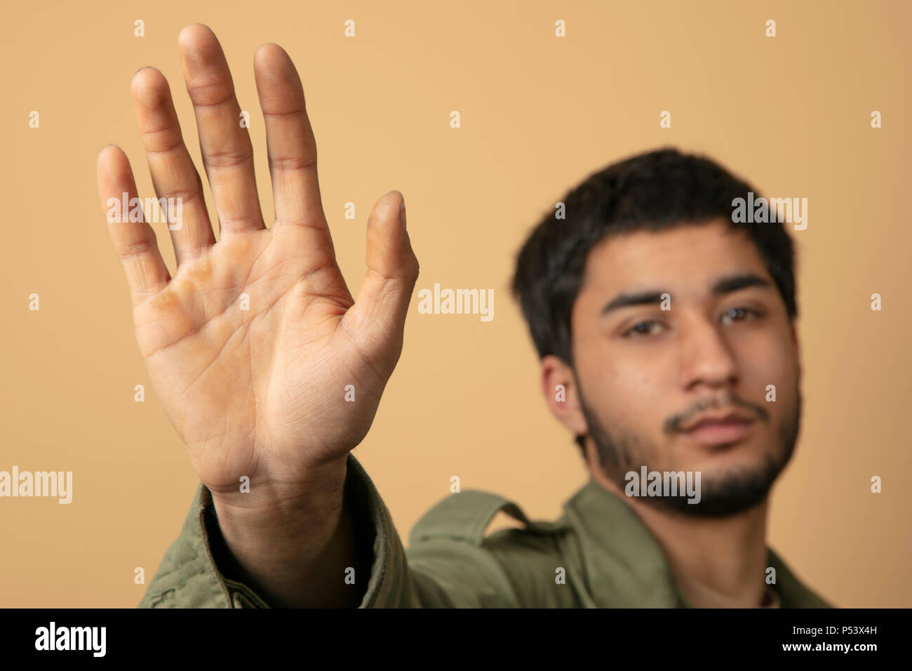 Young Man shows STOP Sign with his hand Stock Photo - Alamy