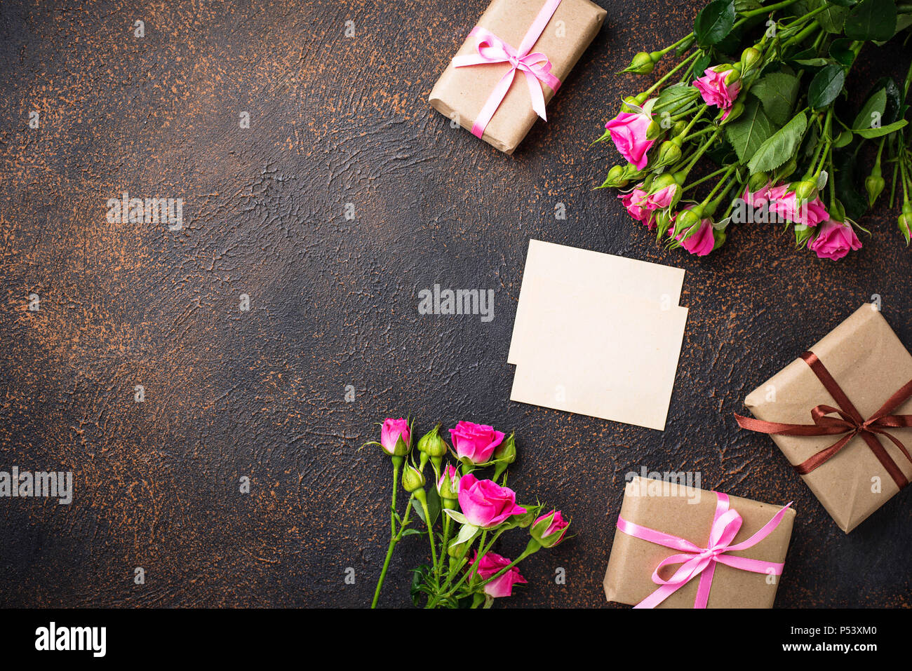 Pink roses, gift boxes and greeting card Stock Photo - Alamy
