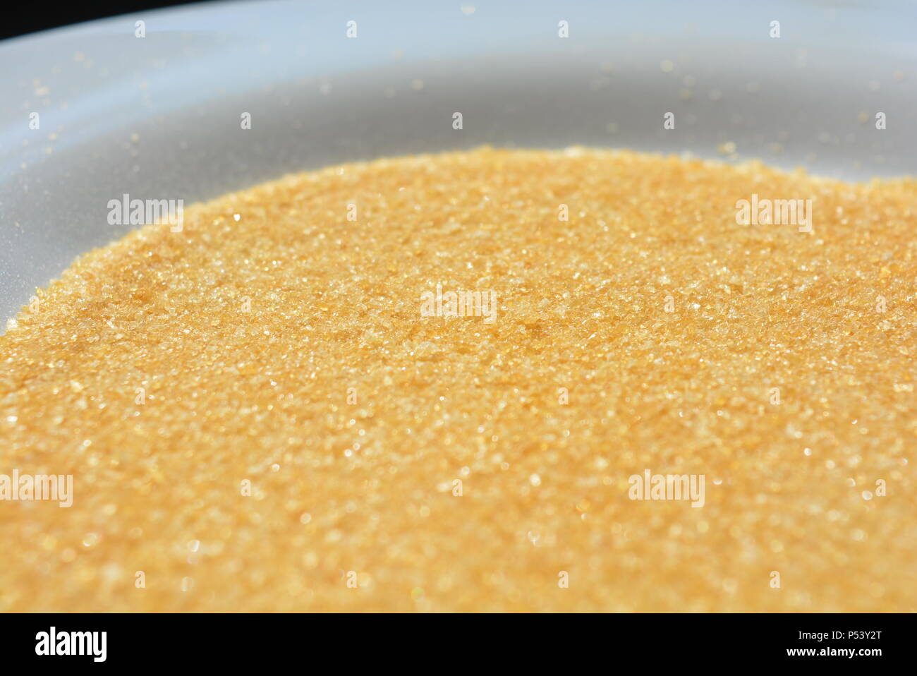 Food, cooking homemade meals. Small yellow grains of gelatin are placed ...