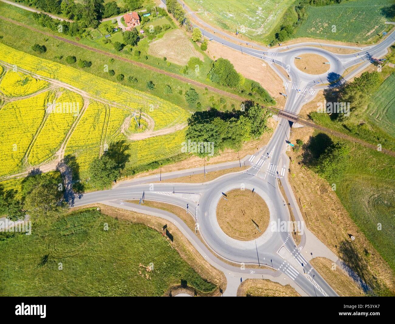 Aerial view of roundabout circles, railroad line and bike lanes near ...