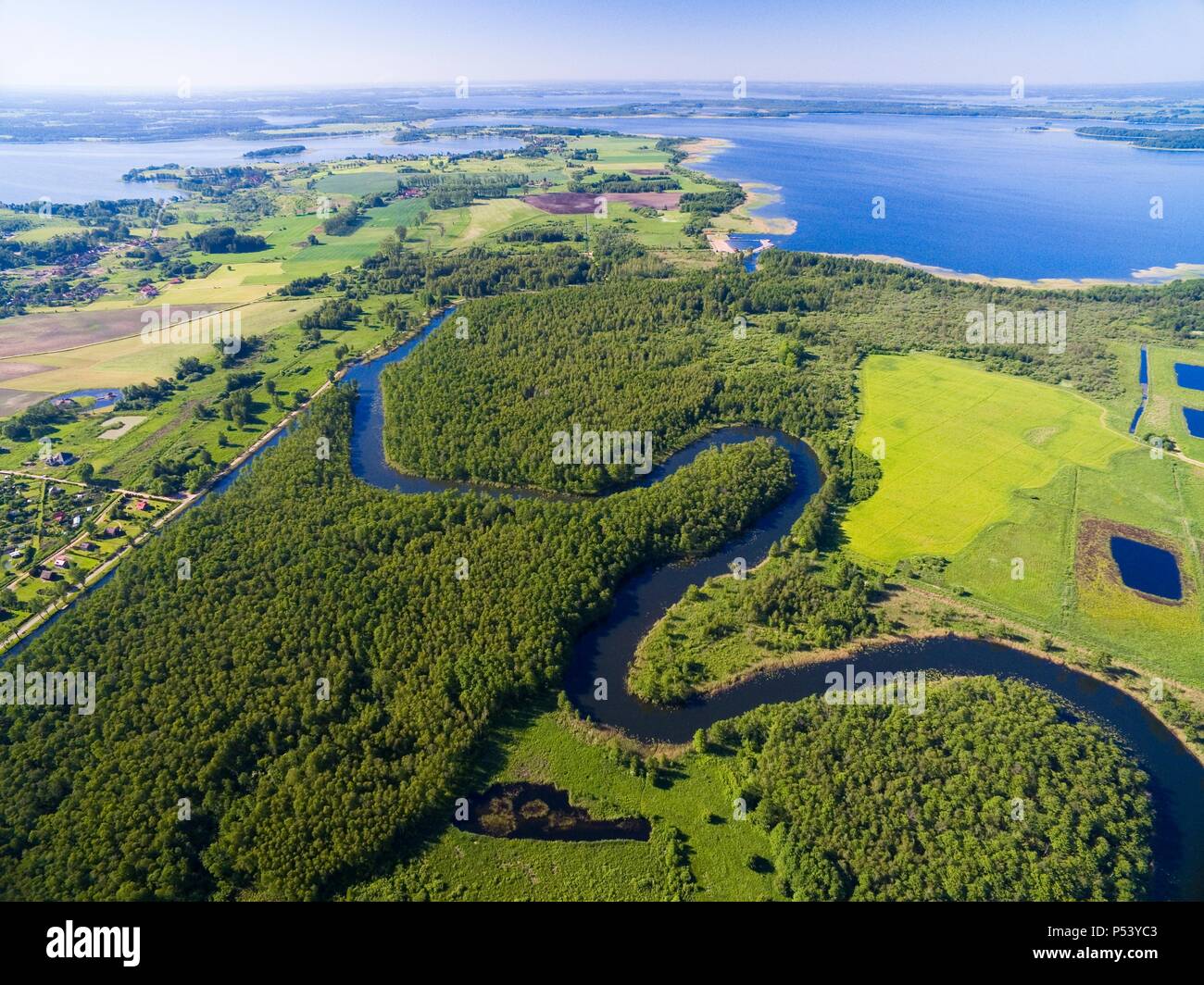 Meander of Wegorapa river flowing across wetlands, Mazury, Poland ...
