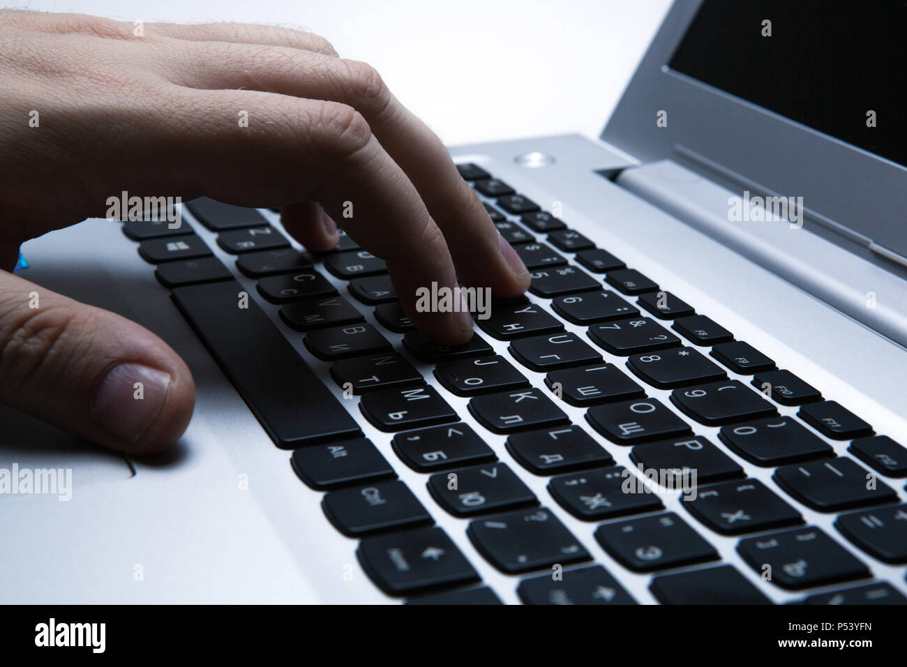 man is typing on a laptop keyboard Stock Photo - Alamy