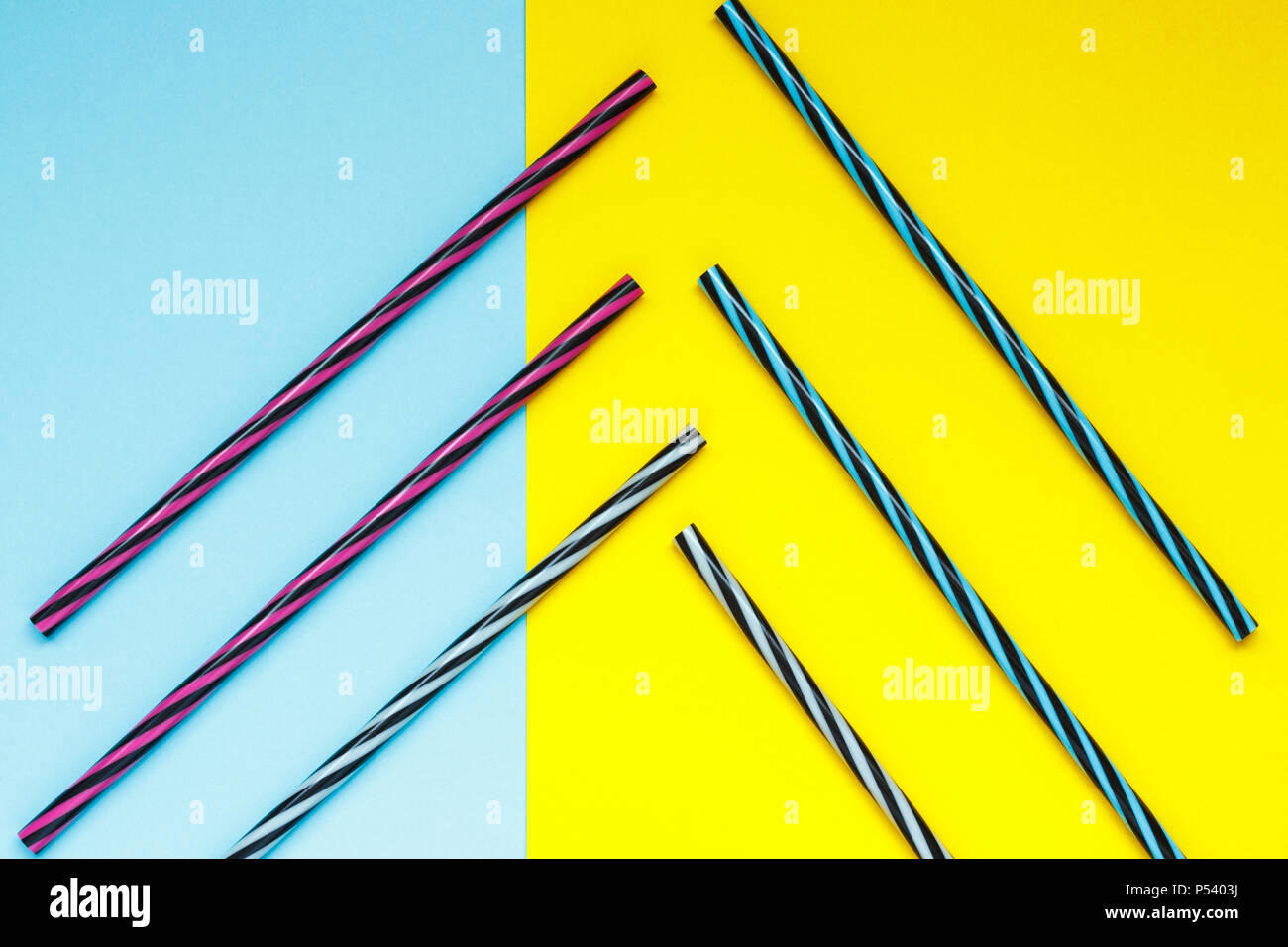 colorful striped straw on a blue and yellow background Stock Photo - Alamy