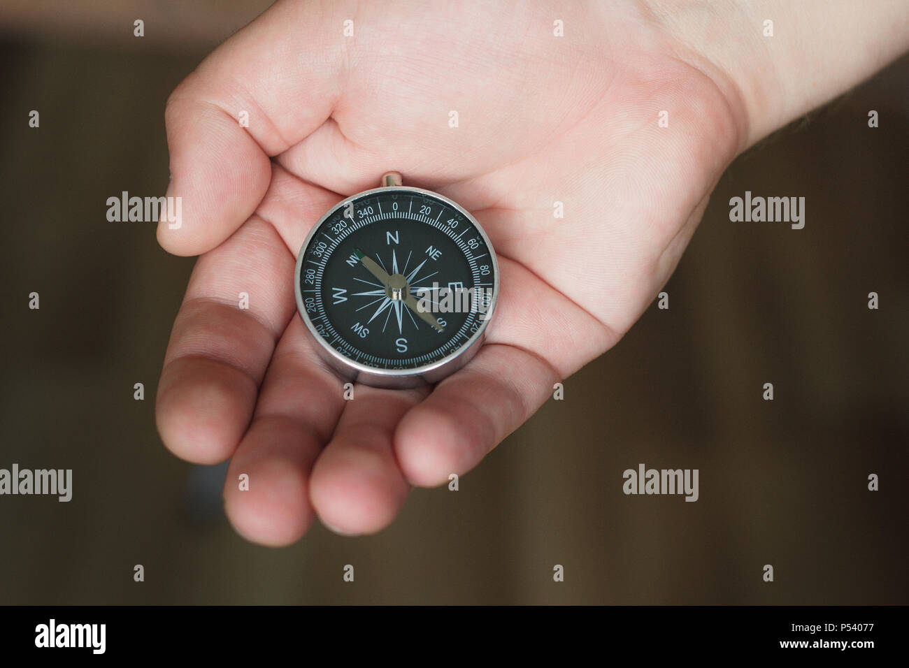 Hand holds compass orientation hi-res stock photography and images - Alamy