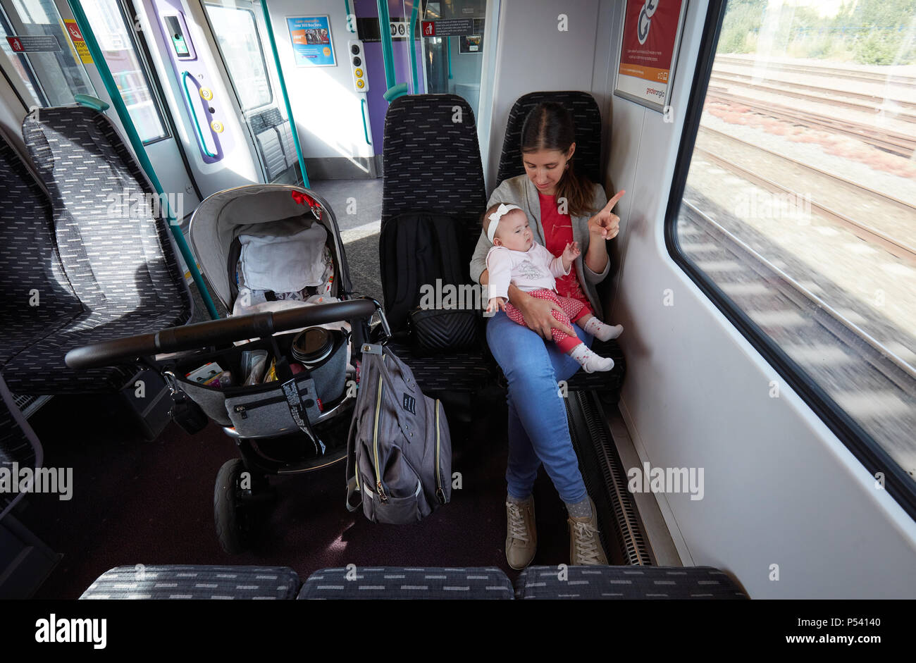 Young mother travelling with baby girl on the train Stock Photo - Alamy