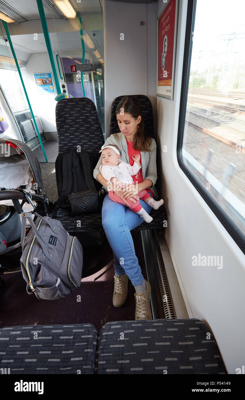 Young mother travelling with baby girl on the train Stock Photo - Alamy