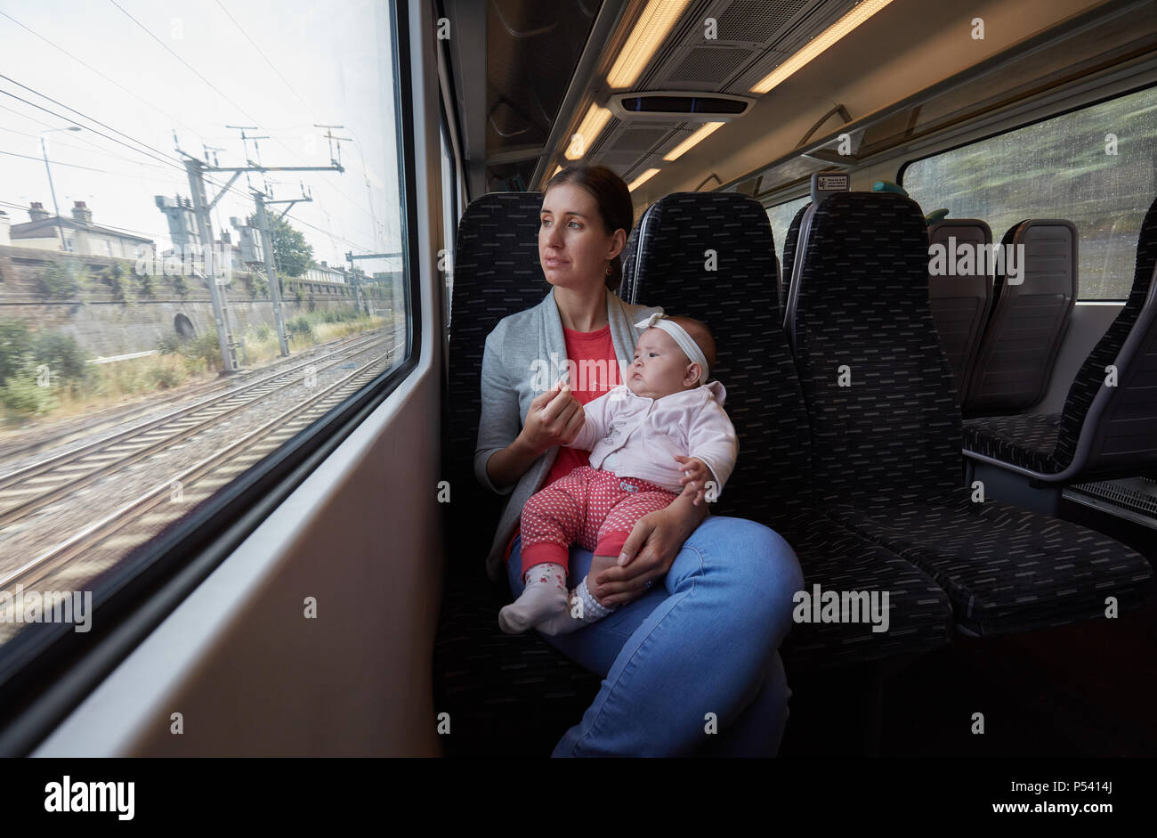 Young mother travelling with baby girl on the train Stock Photo - Alamy